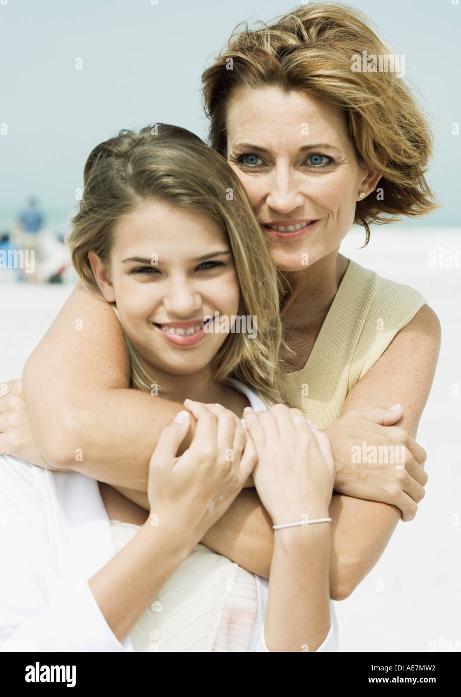 Mother with arms around teenage daughter, portrait Stock Photo - Alamy