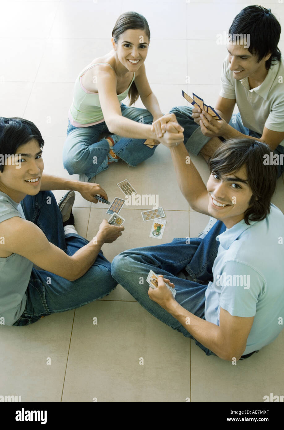 Four friends playing game cards hi-res stock photography and images - Alamy