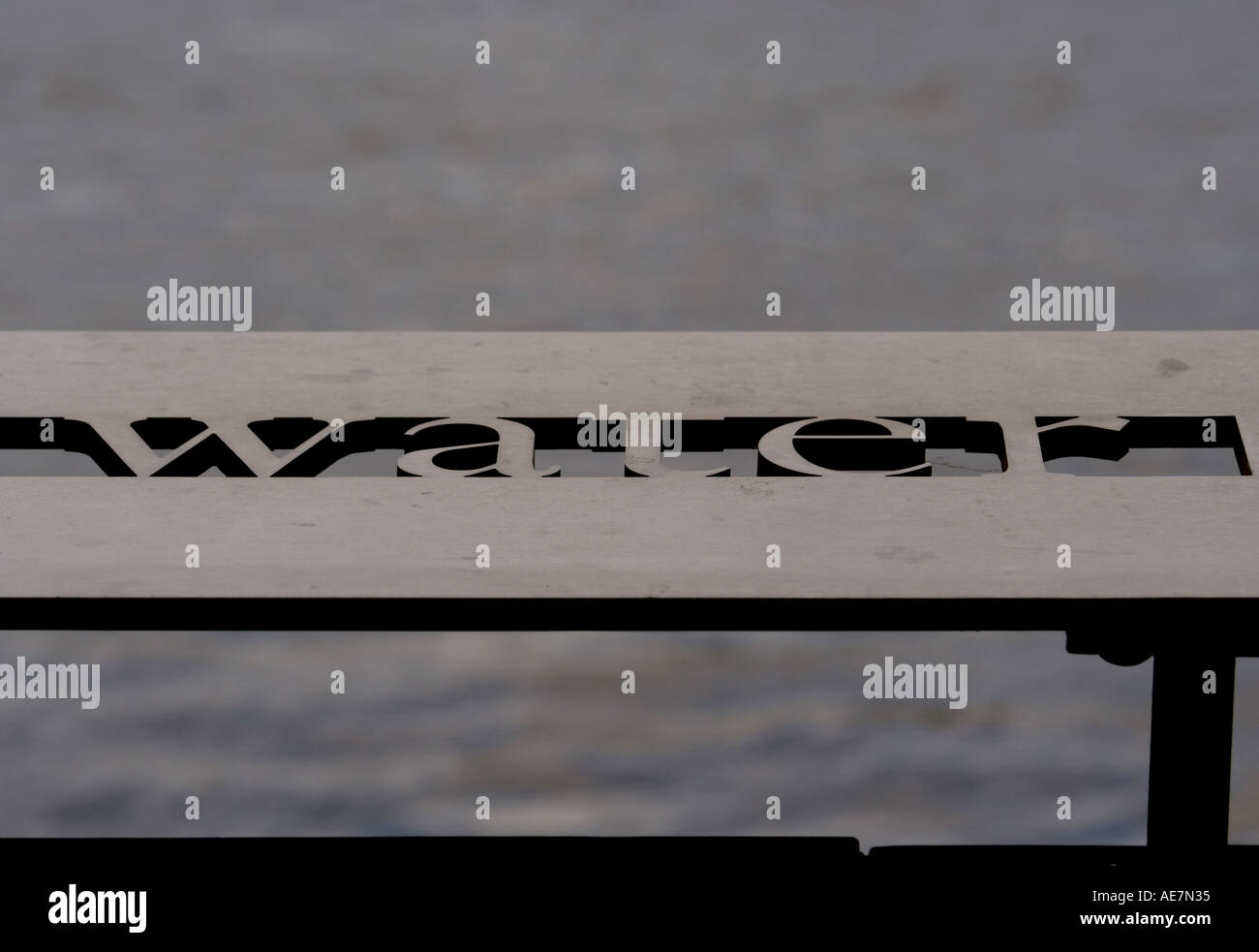 the word water engraved in a metal sign on the side of the river thames ...
