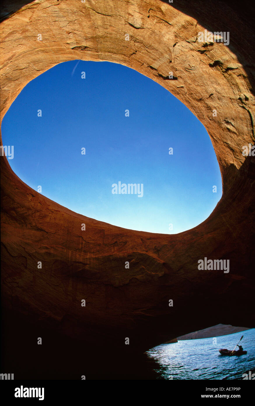 Kayaking into a double arch of sandstone in Rock Creek Bay, Lake Powell ...