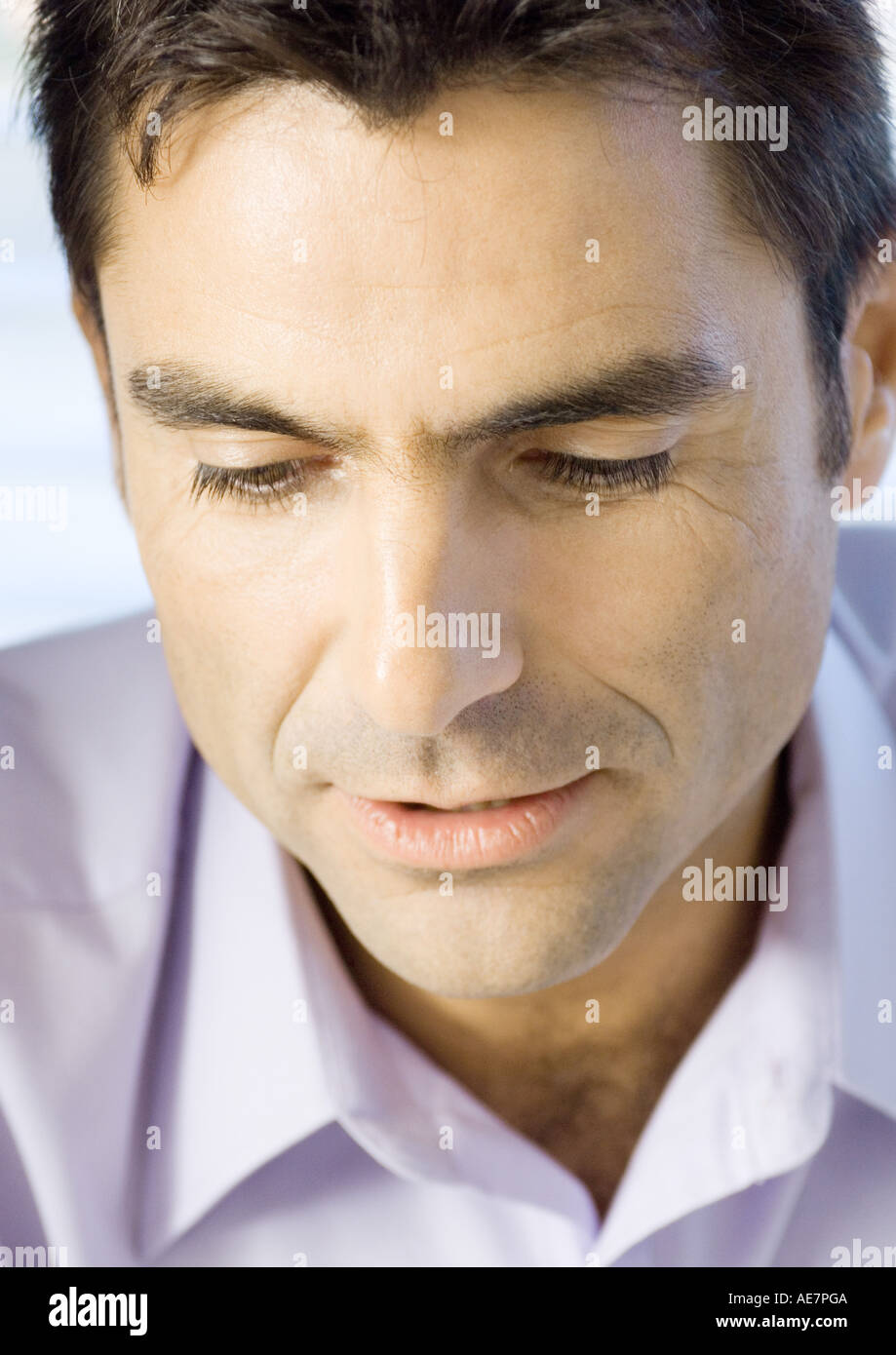 Man looking down, close-up of head, portrait Stock Photo - Alamy