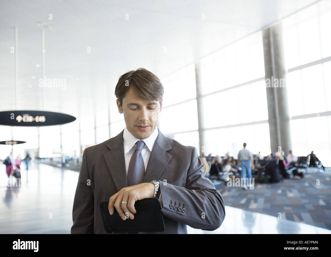 Businessman checking time on watches hi-res stock photography and ...