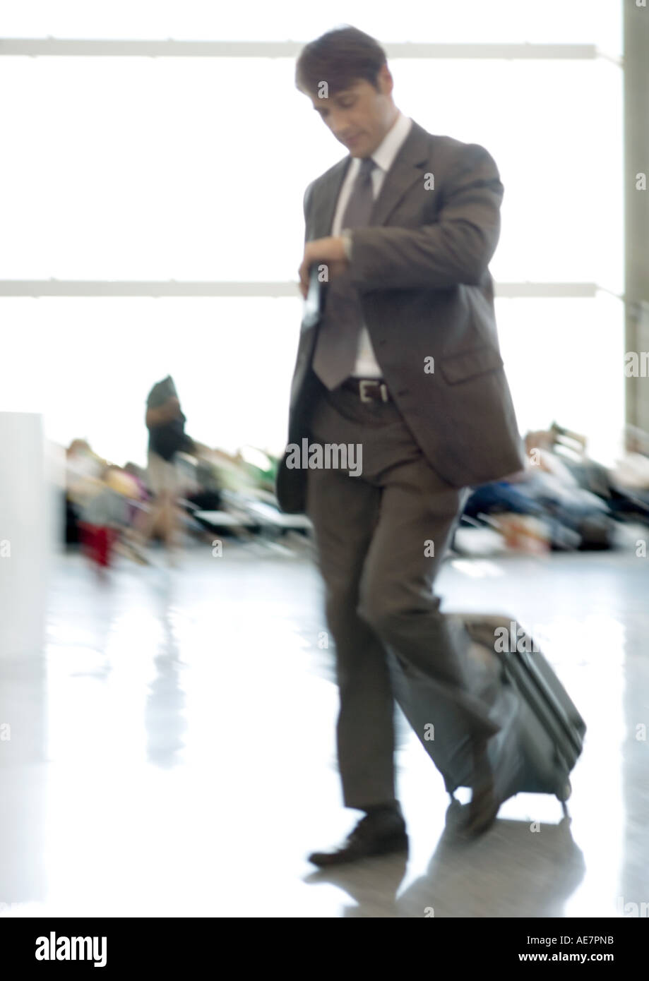 Businessman checking watch walks through hi-res stock photography and ...