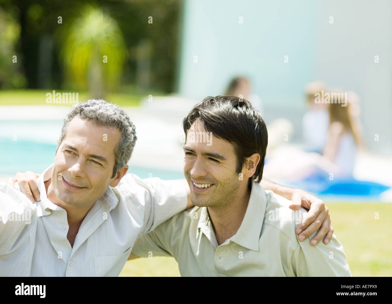 Two men with arms around each other's shoulders, smiling Stock Photo ...