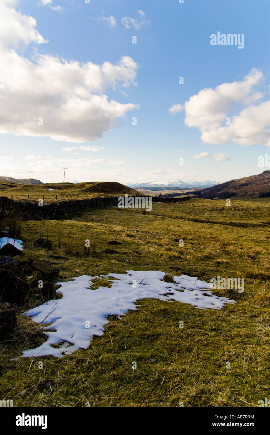 Landscape with patch of snow melting on grass Stock Photo - Alamy