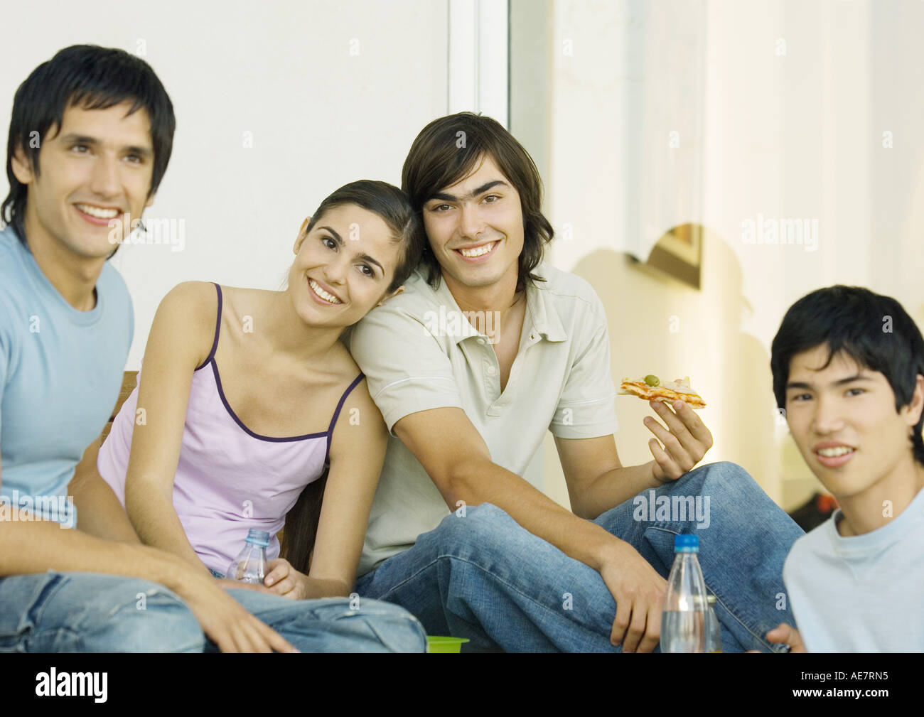 Young adult friends hanging out and eating together Stock Photo - Alamy