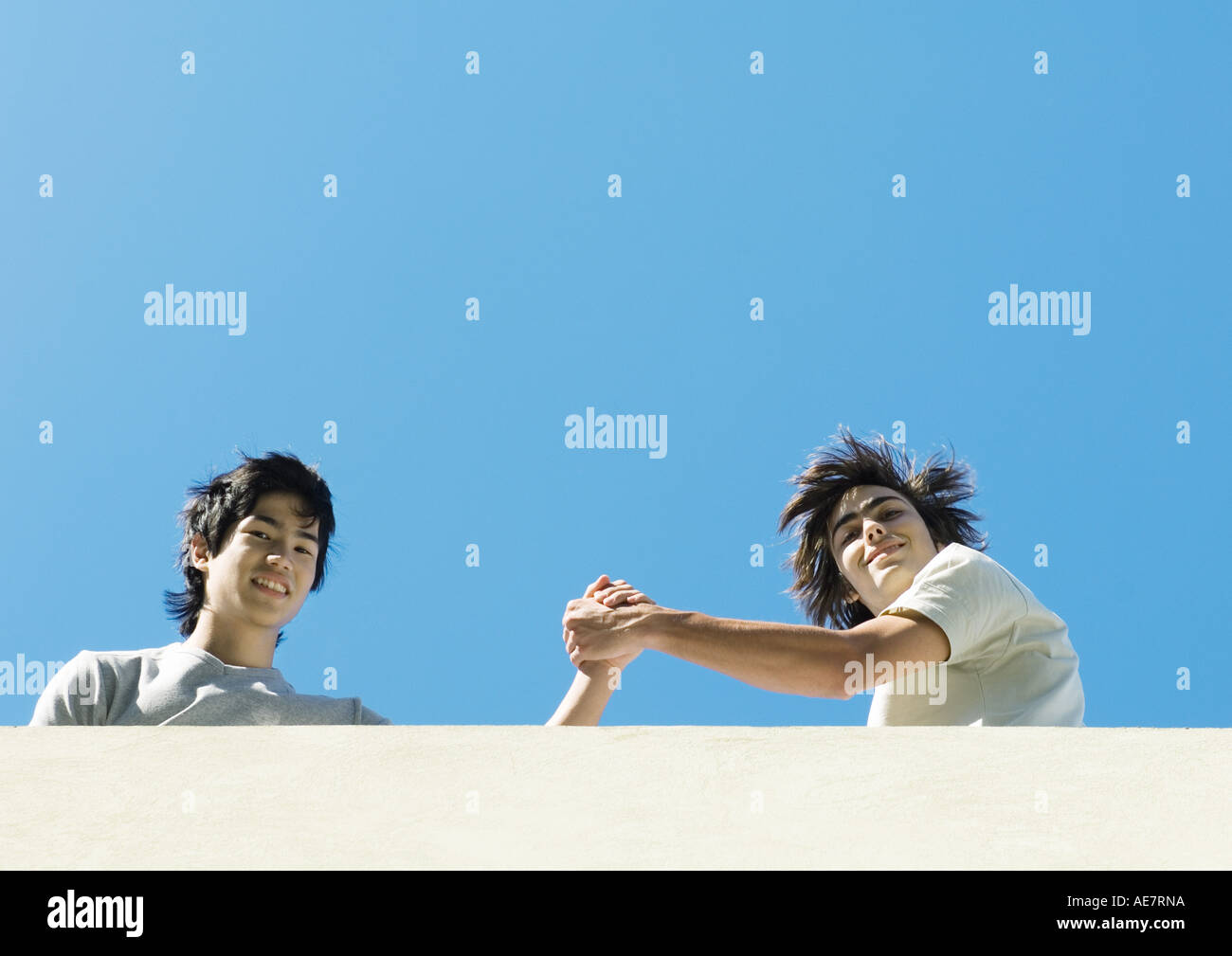 Two teen boys holding hands hi-res stock photography and images - Alamy