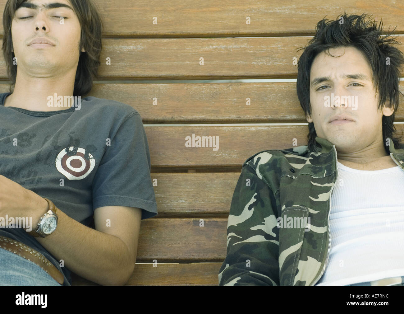 Two young male friends, one with eyes closed Stock Photo - Alamy