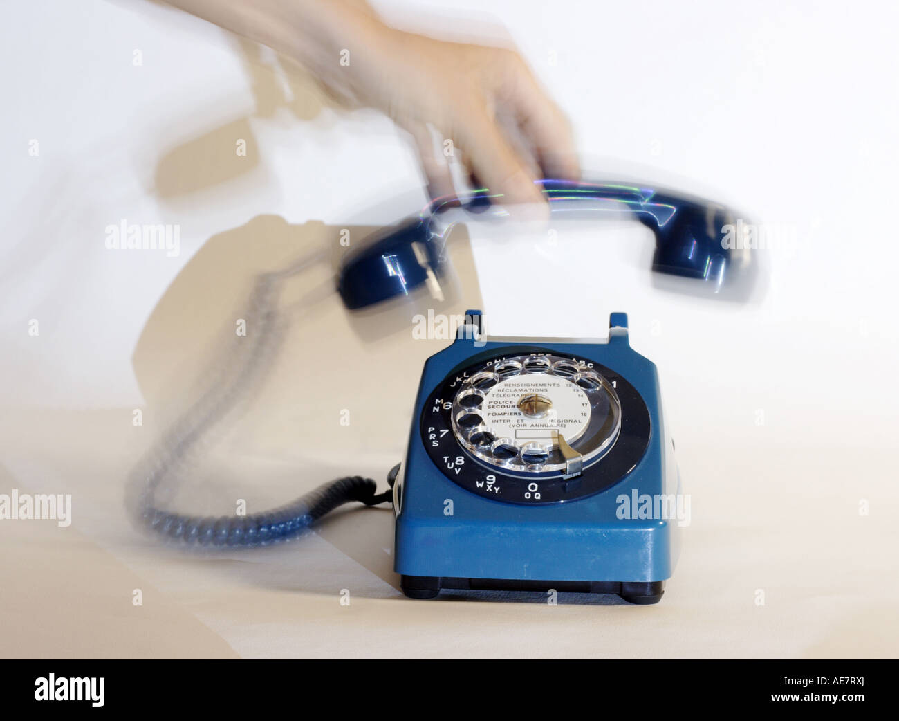 hand picking up the receiver of an old retro phone Stock Photo - Alamy