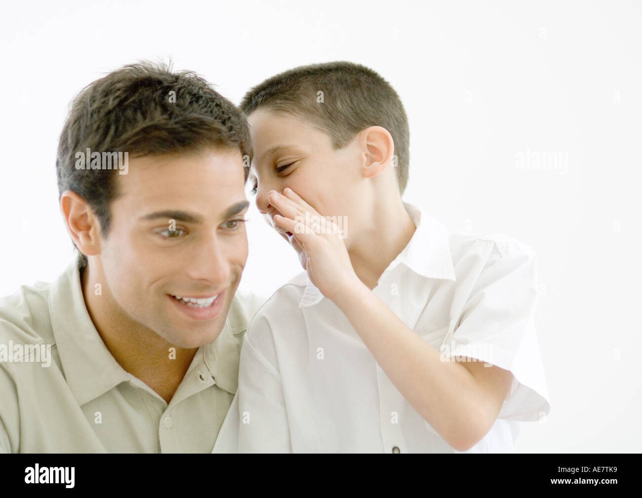 Boy whispering to father Stock Photo - Alamy
