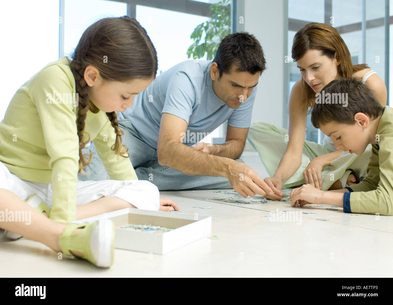 Family putting together puzzle Stock Photo - Alamy Family putting together puzzle Stock Photo - Alamy