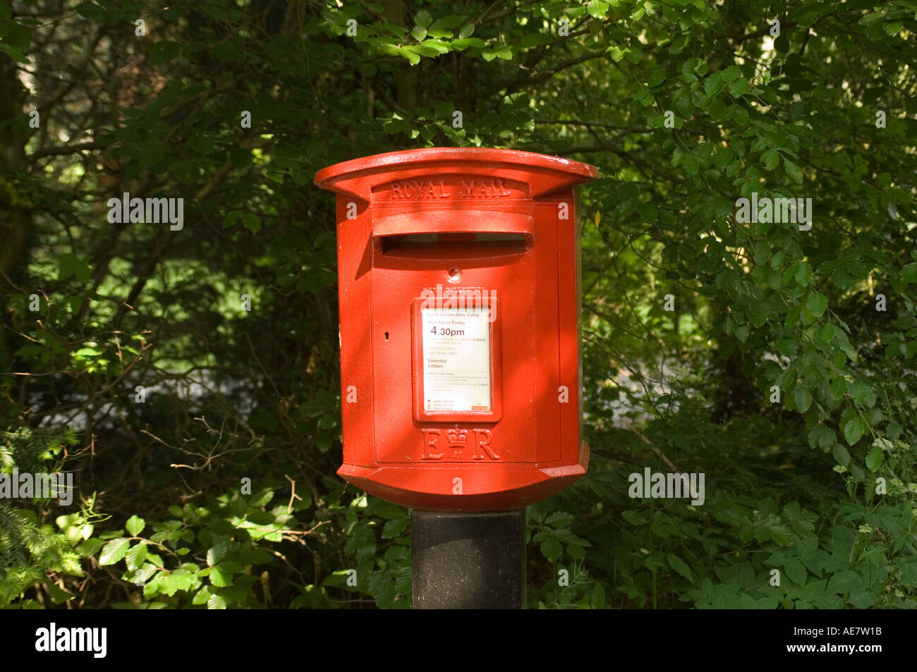 Small Red UK postbox in a country lane Stock Photo - Alamy