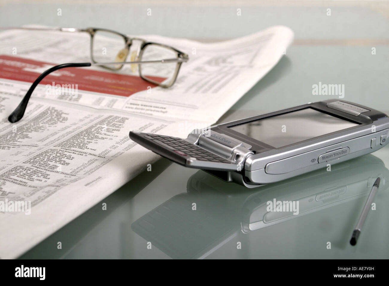 newspaper with glasses and mobile phone Stock Photo - Alamy