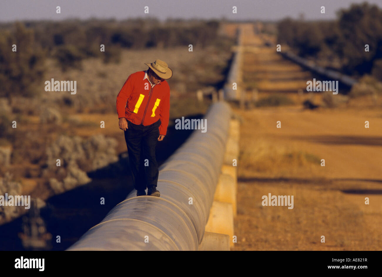 Man inspects water pipeline South Australia Stock Photo - Alamy