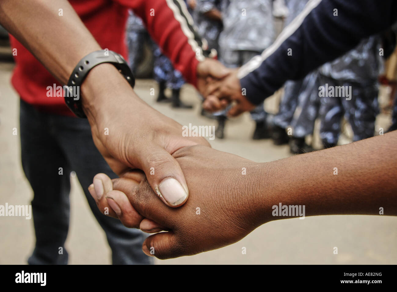 Police holding hands hi-res stock photography and images - Alamy