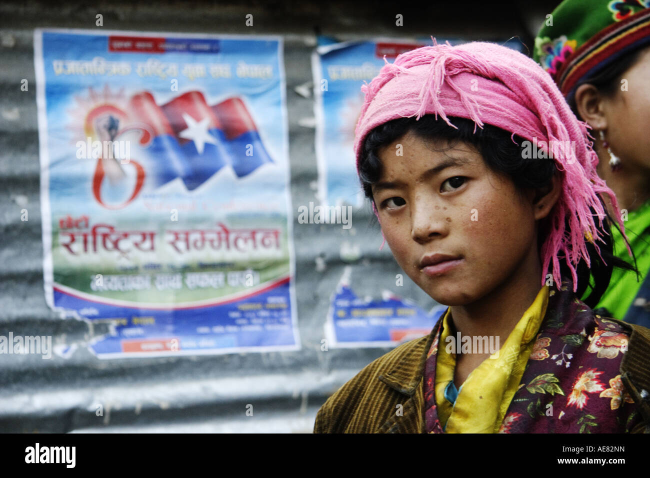 Portrait of Tamang girl in front of political poster Stock Photo - Alamy