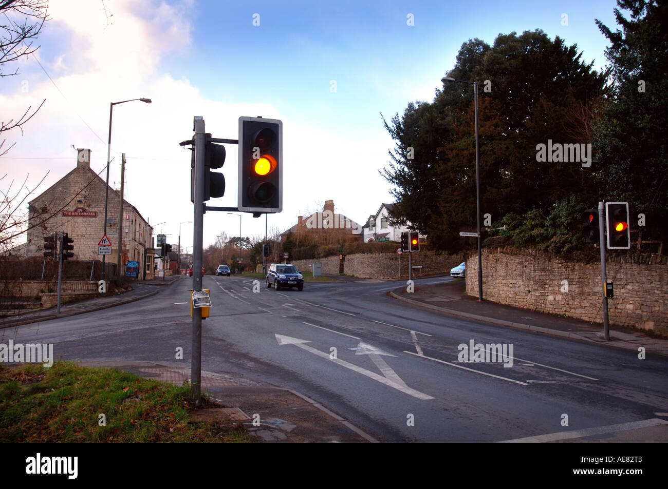 TRAFFIC LIGHTS SHOWING AMBER AT A CROSSROADS IN THE UK Stock Photo - Alamy