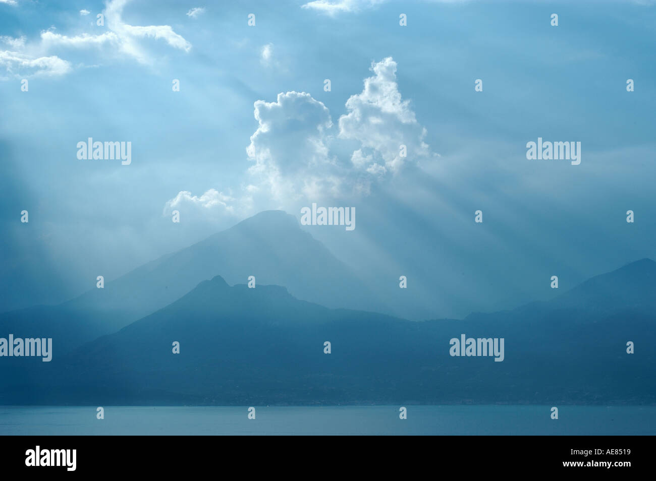 Sun rays emitting on mountain range, Lake Garda, Malcesine, Veneto ...