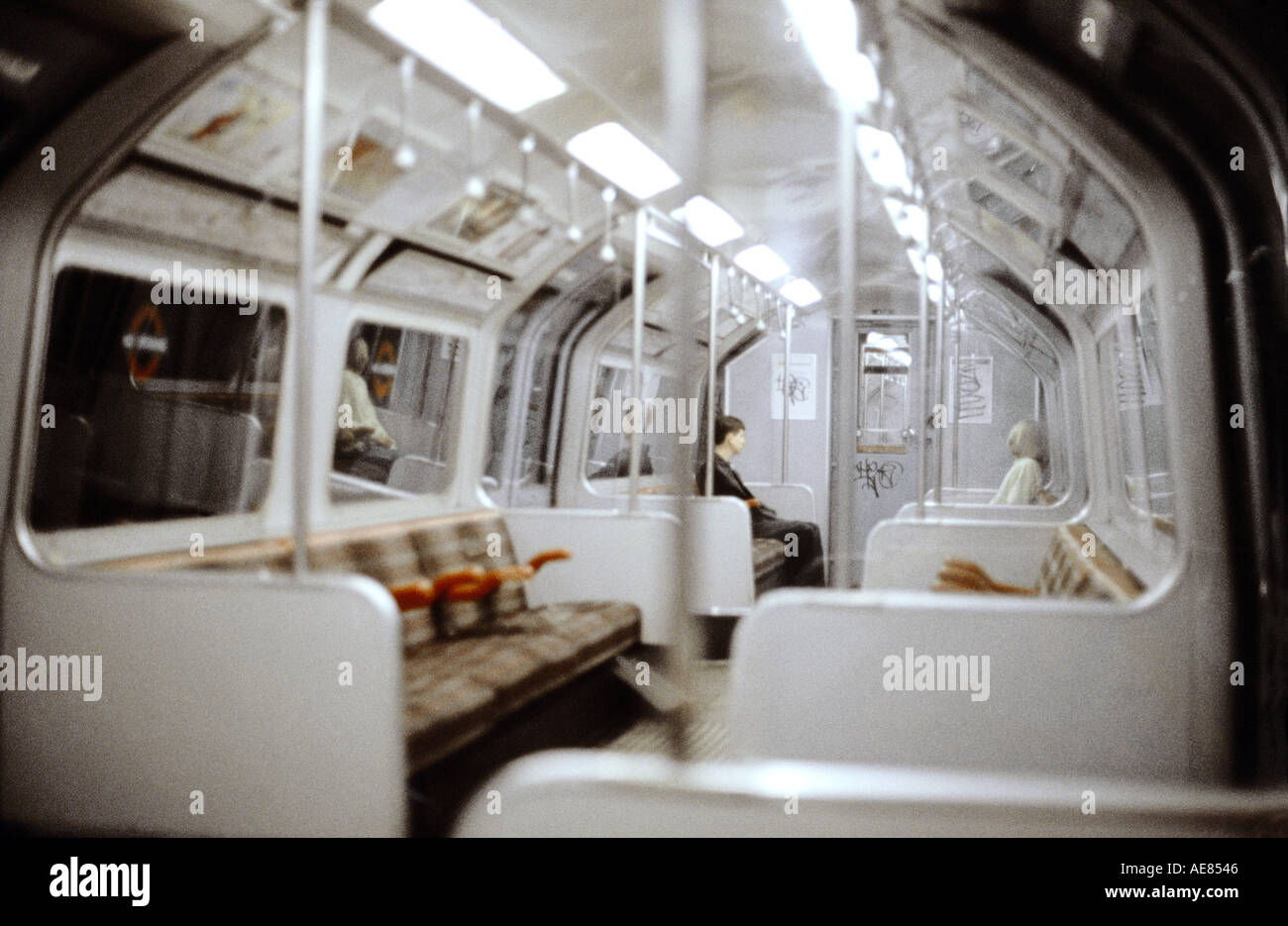 Side profile two people sitting in train Stock Photo - Alamy