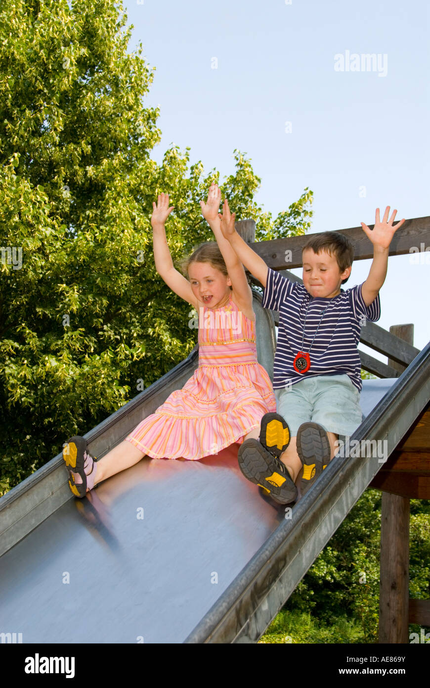 Happy boy going down slide hi-res stock photography and images - Alamy