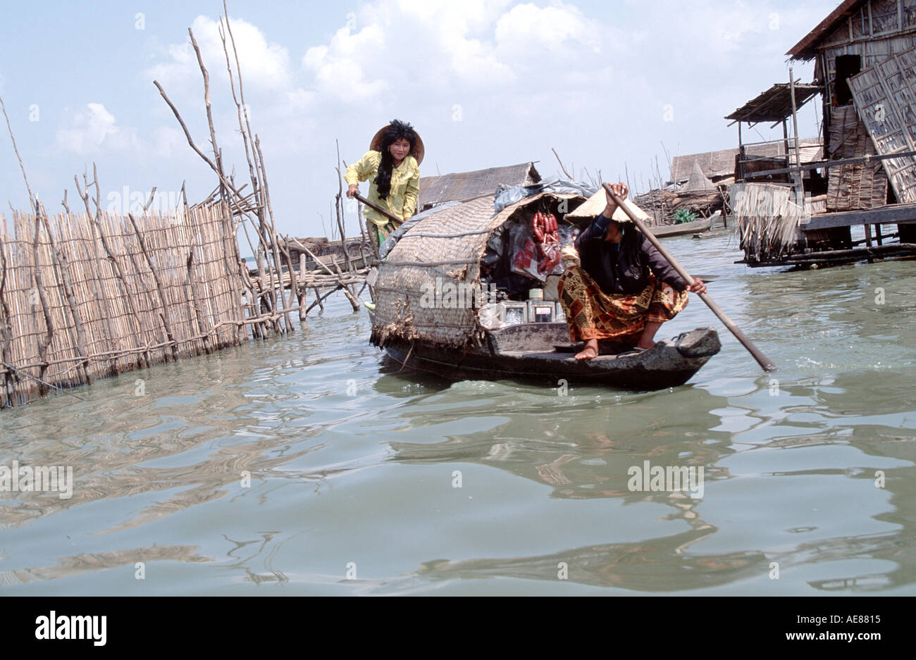 Cambodia Tonli Sap Lake floating shop traveling between the house boats ...