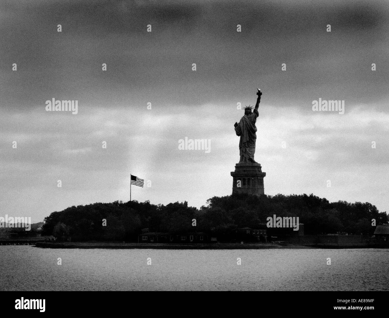 Gritty, overcast view of Ellis Island and the Statue of Liberty, New ...