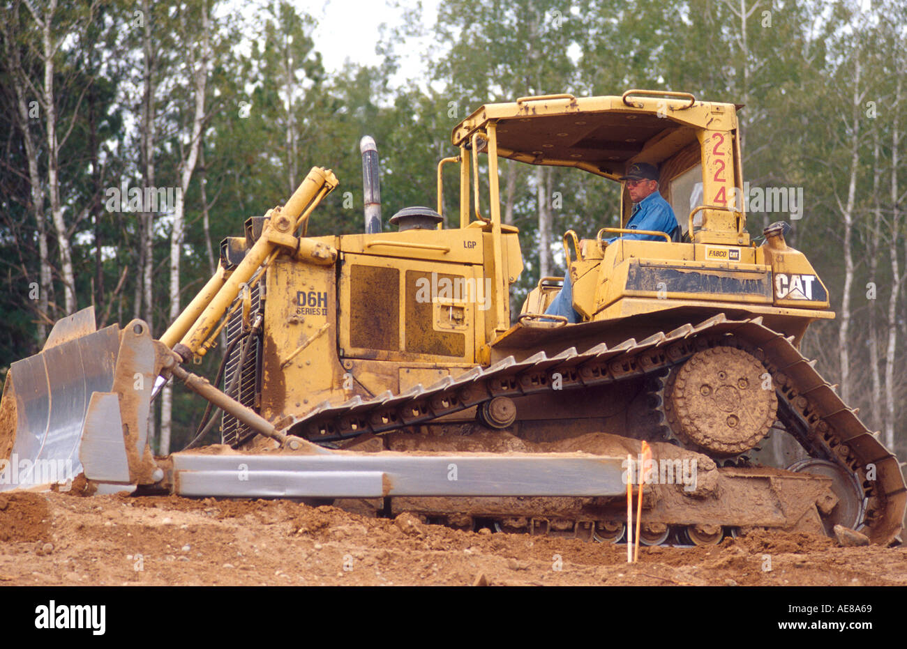 Bulldozer tractor pushing dirt on highway construction project Stock ...