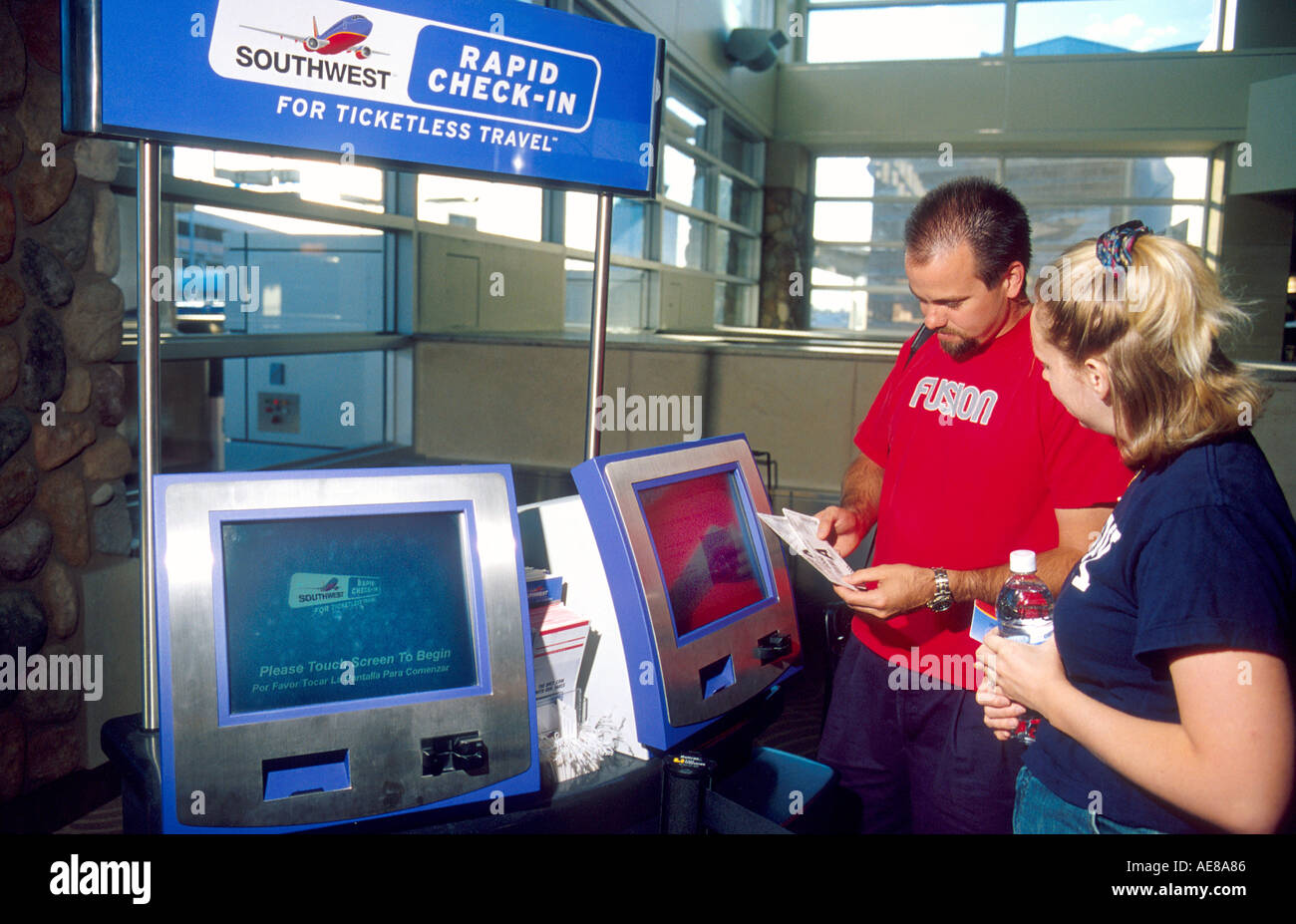 Airline electronic ticket check in at airport Stock Photo - Alamy