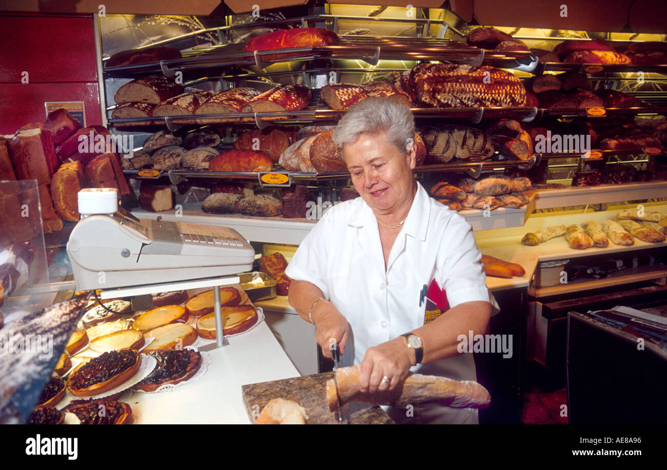 Bakery worker in Cologne Germany slices bread Stock Photo - Alamy