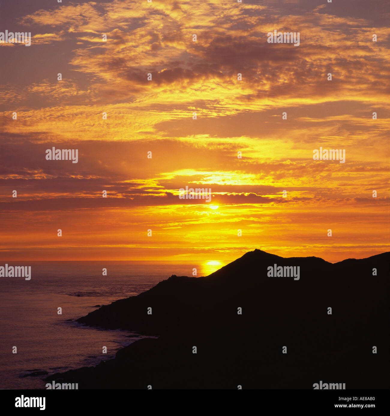 Sunset of gold orange red yellow over Atlantic Ocean and Morthoe Point ...
