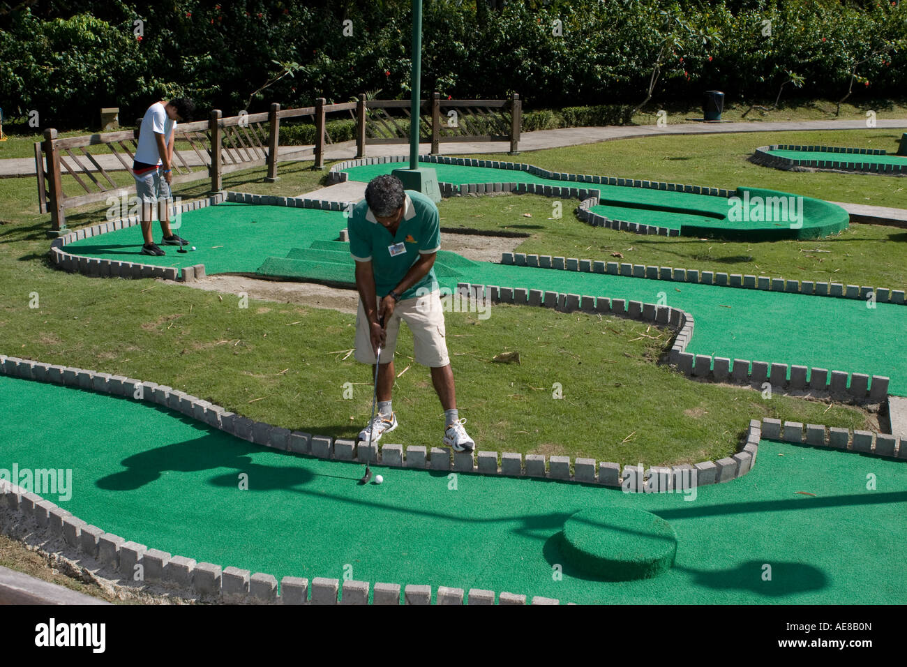 man playing mini golf Stock Photo - Alamy