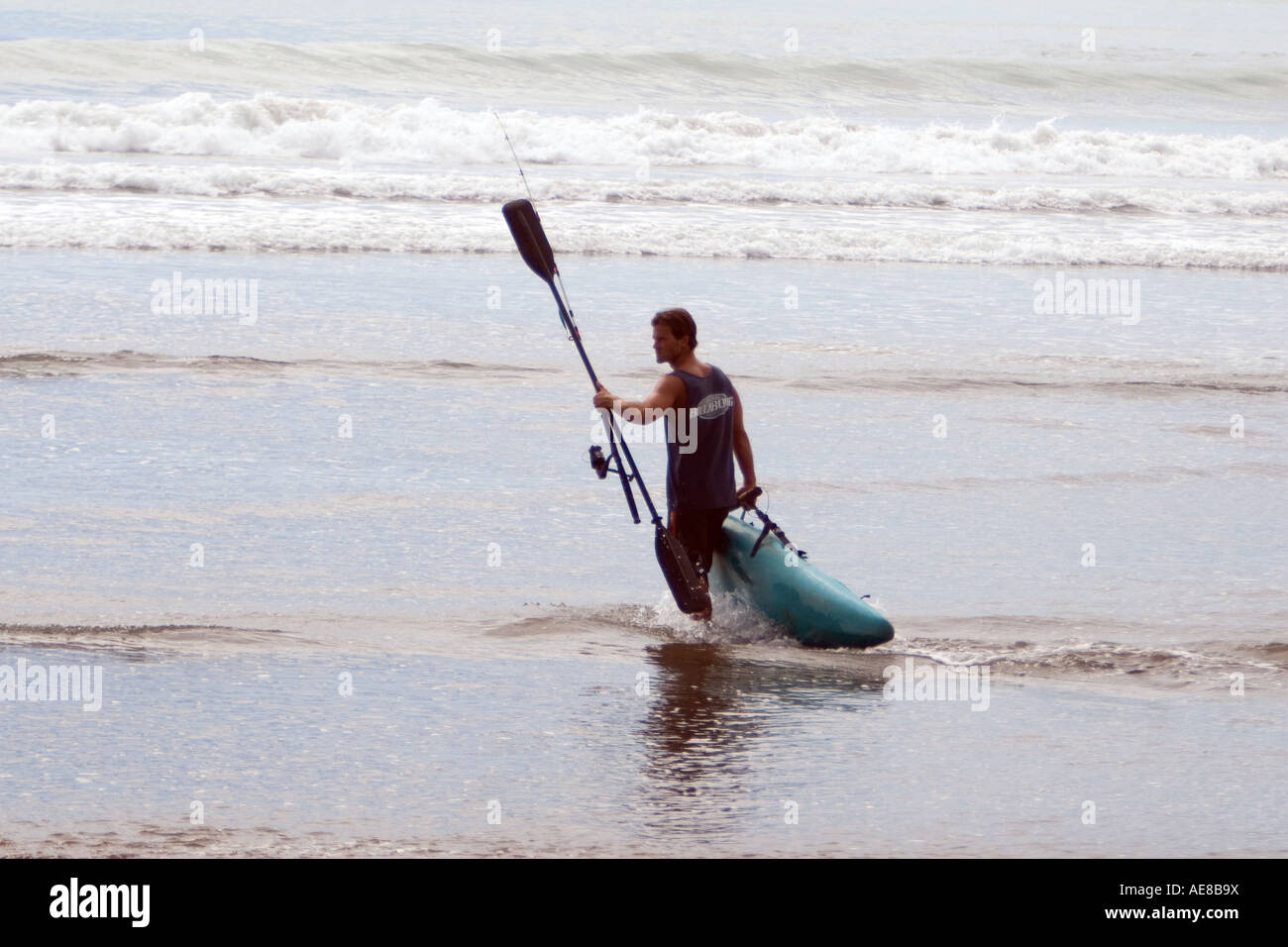 male walking with a ocean kayak Stock Photo - Alamy