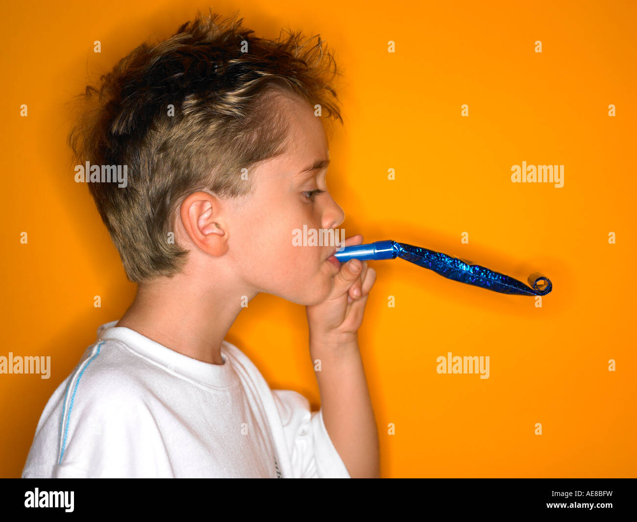 child blowing a party popper Stock Photo - Alamy