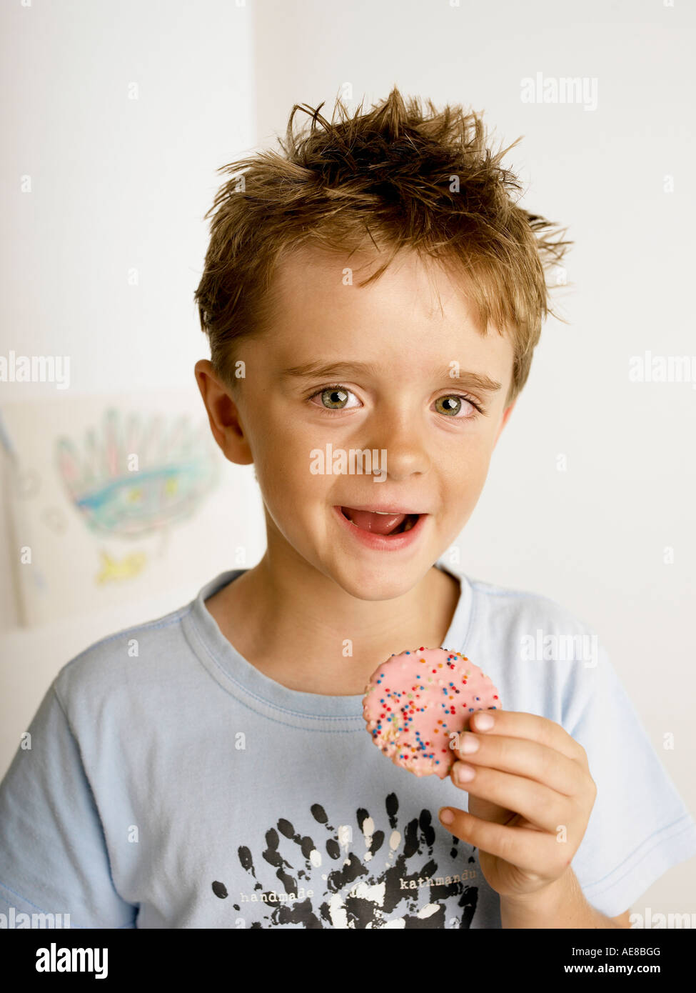 young boy 7 eating a biscuit Stock Photo - Alamy