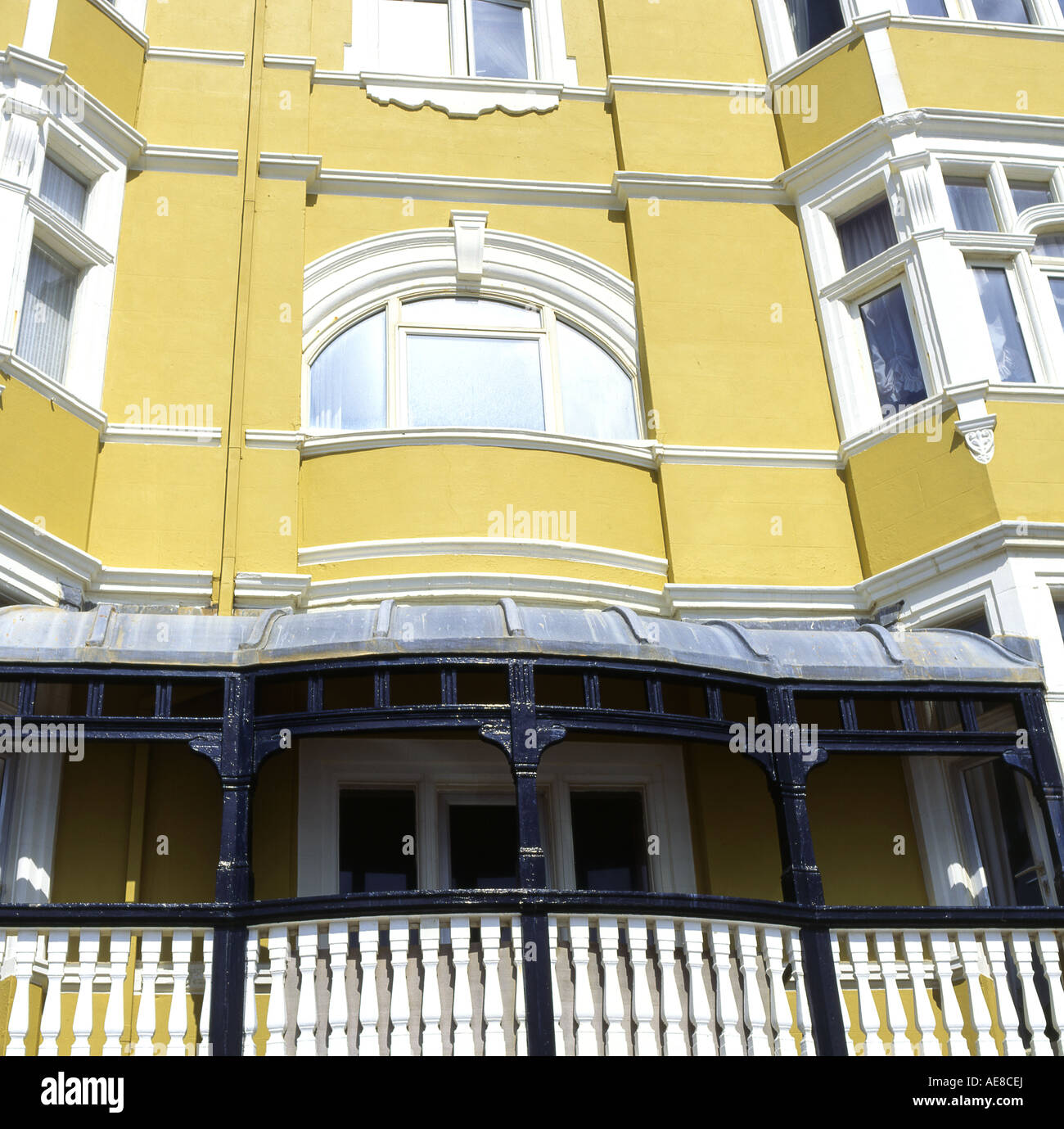 Yellow painted apartment building with balcony Regency Style Brighton ...