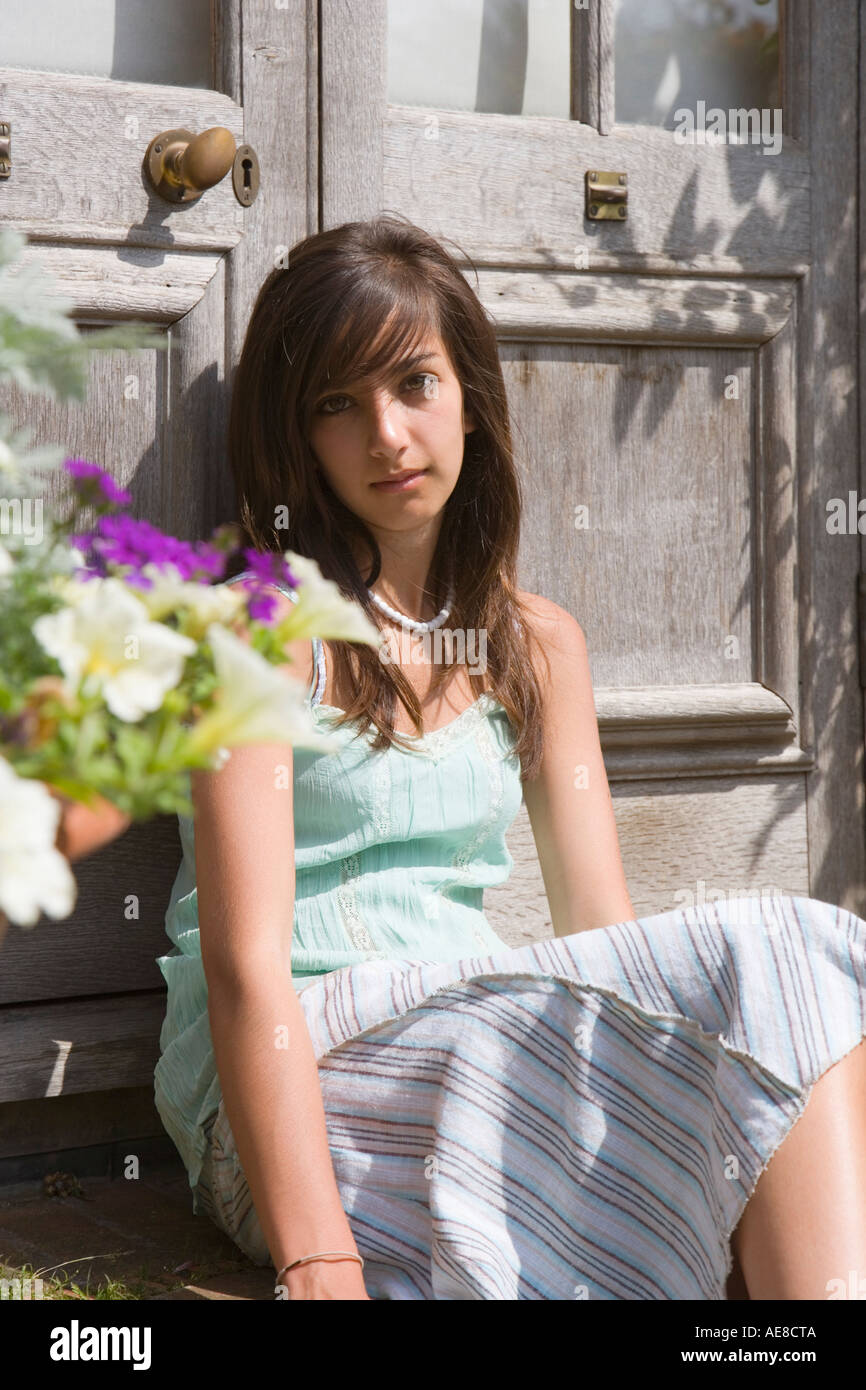 Girl sitting on doorstep hi-res stock photography and images - Alamy