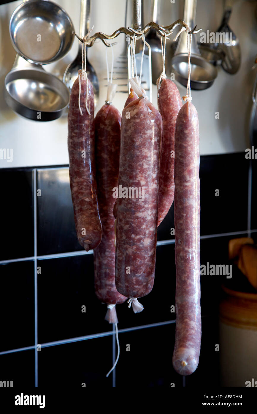 home made salami hanging on old traditional butchers hooks Stock Photo ...