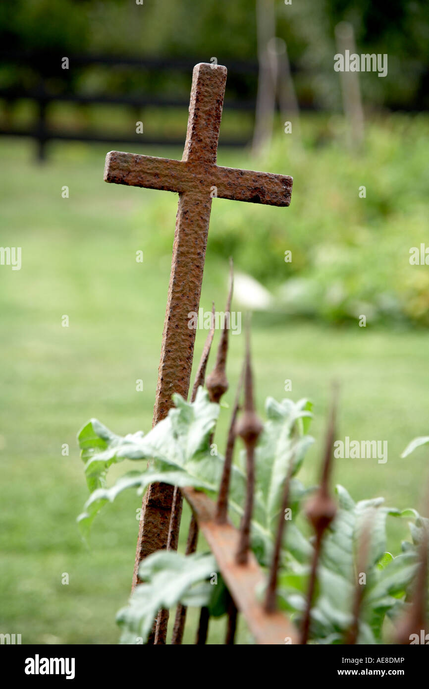 wrought iron fence with cross at the edge vegetable patch Stock Photo ...
