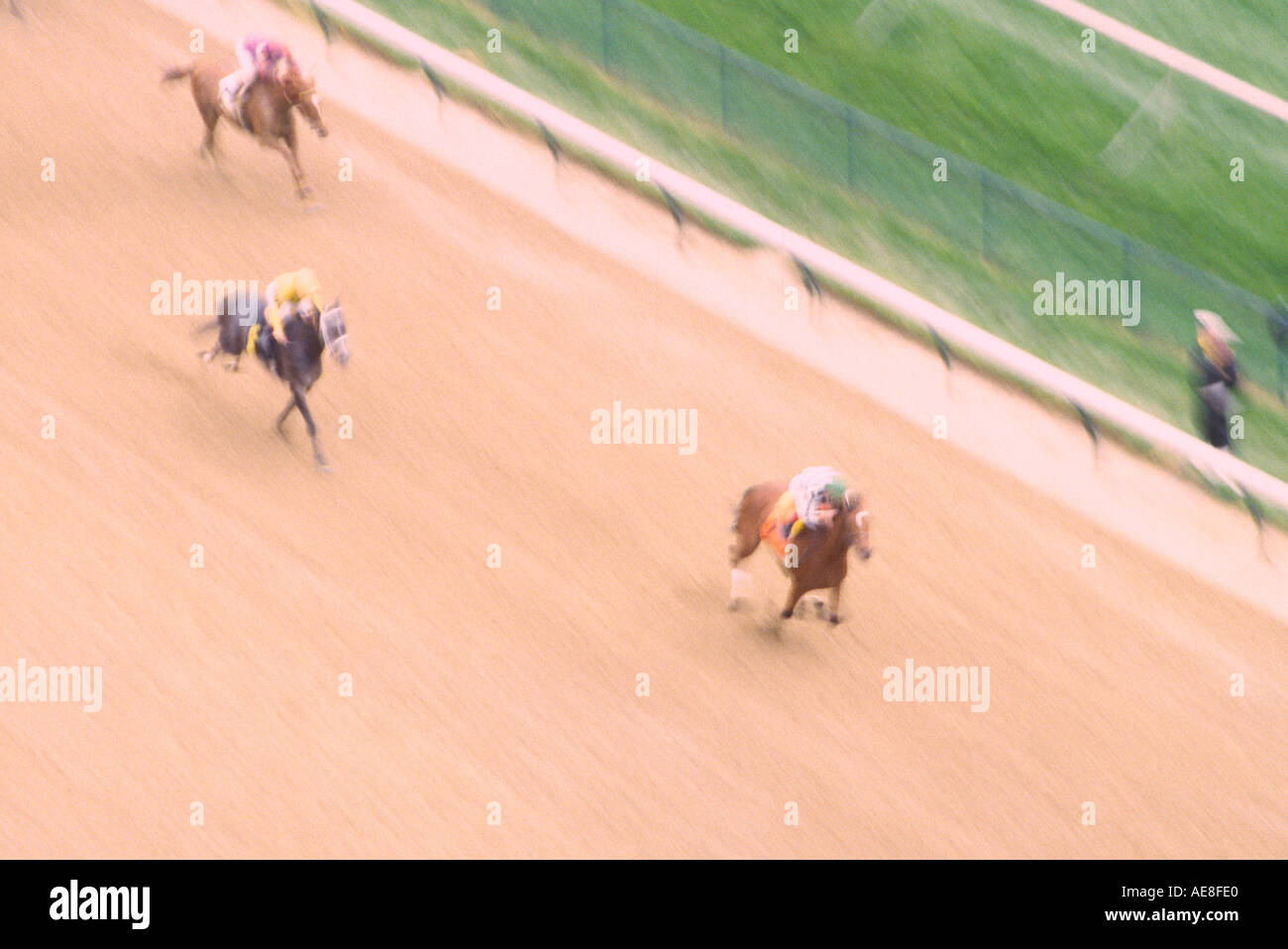 Three horses racing at a race track hi-res stock photography and images ...