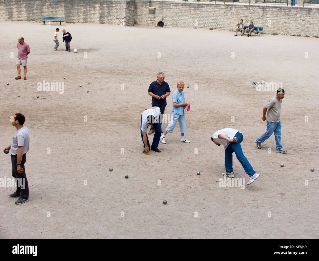 Frenchmen playing boccie on dirt field of the Arenes de Lutece Paris ...
