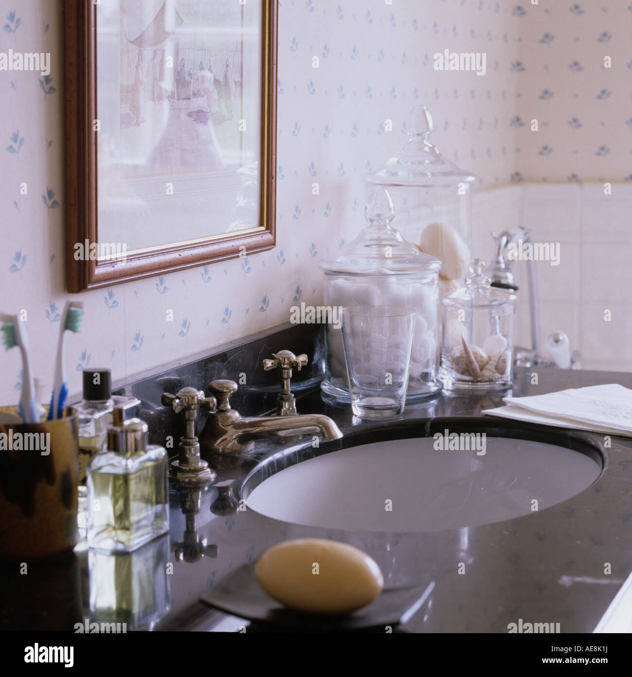 Traditionally English bathroom sink with black marble surface in ...