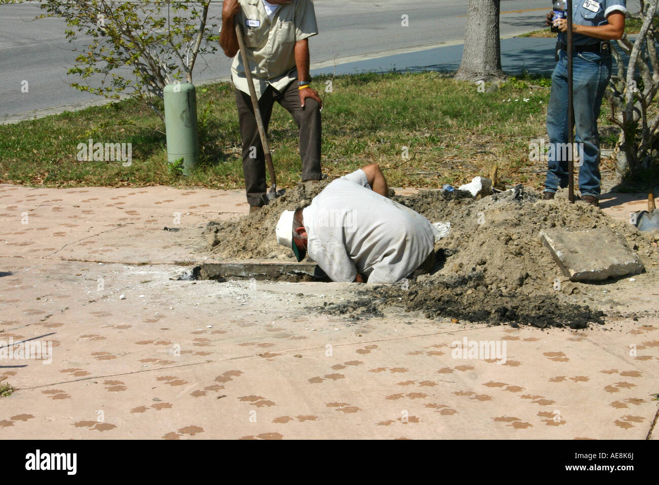 Construction Workers digging a Hole in a Concrete Slab Stock Photo - Alamy Construction Workers digging a Hole in a Concrete Slab Stock Photo - Alamy
