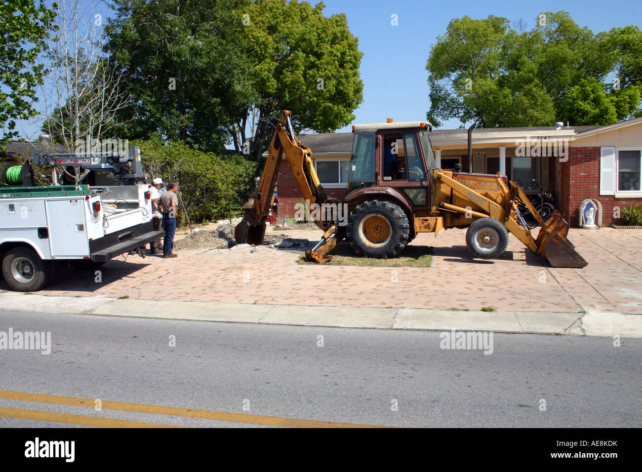 Construction Workers digging a Hole in a Concrete Slab Stock Photo - Alamy