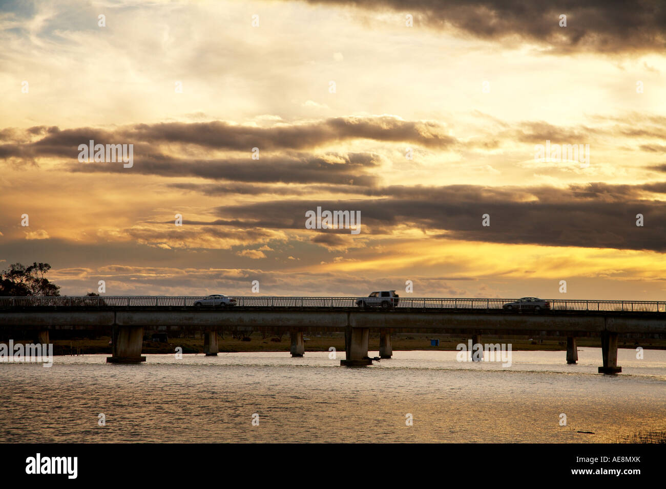 cars crossing bridge at sunset Stock Photo - Alamy