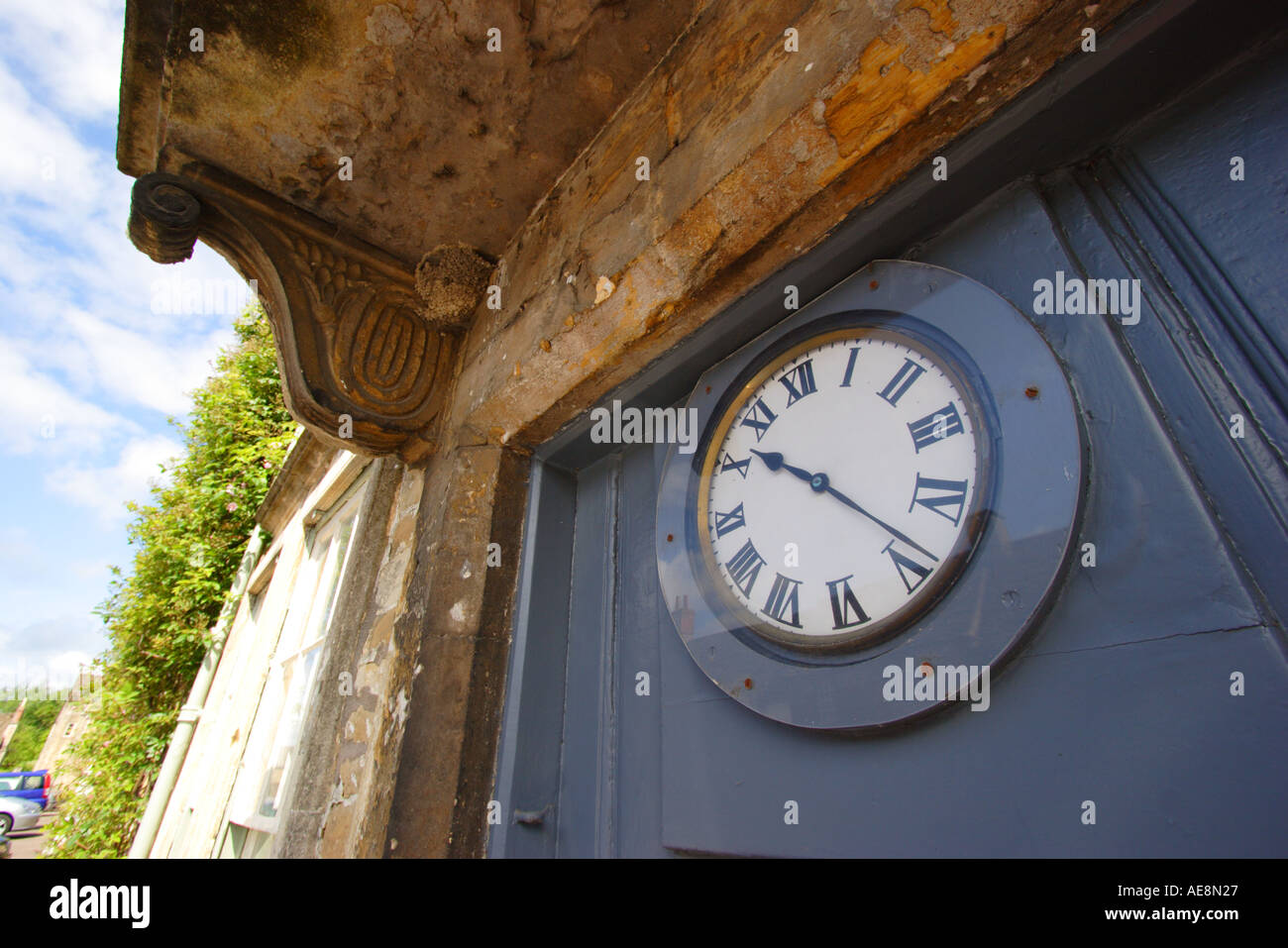 Unusual clock set in door of old house in Lacock Stock Photo - Alamy