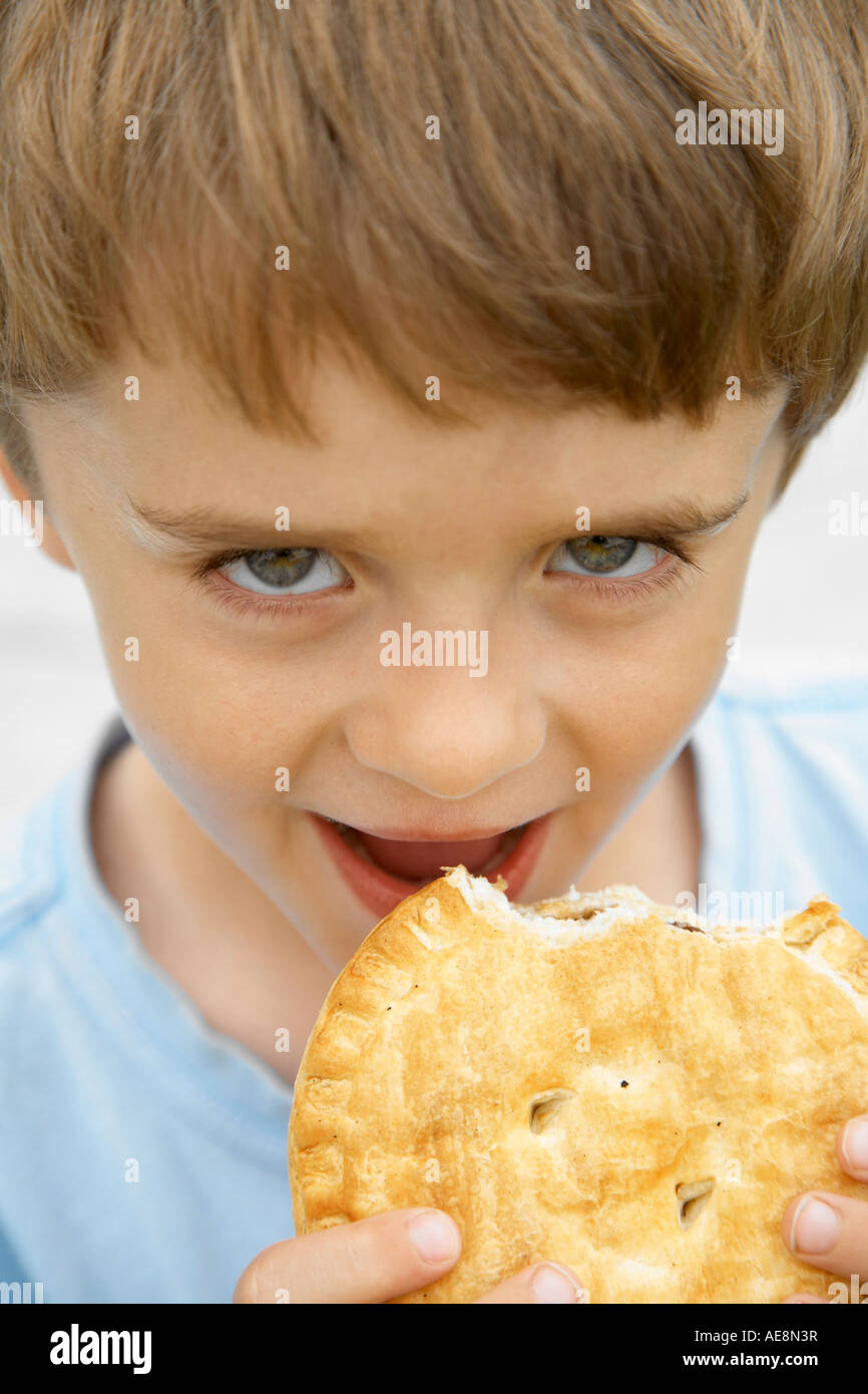boy 7 eating pie for lunch Stock Photo - Alamy