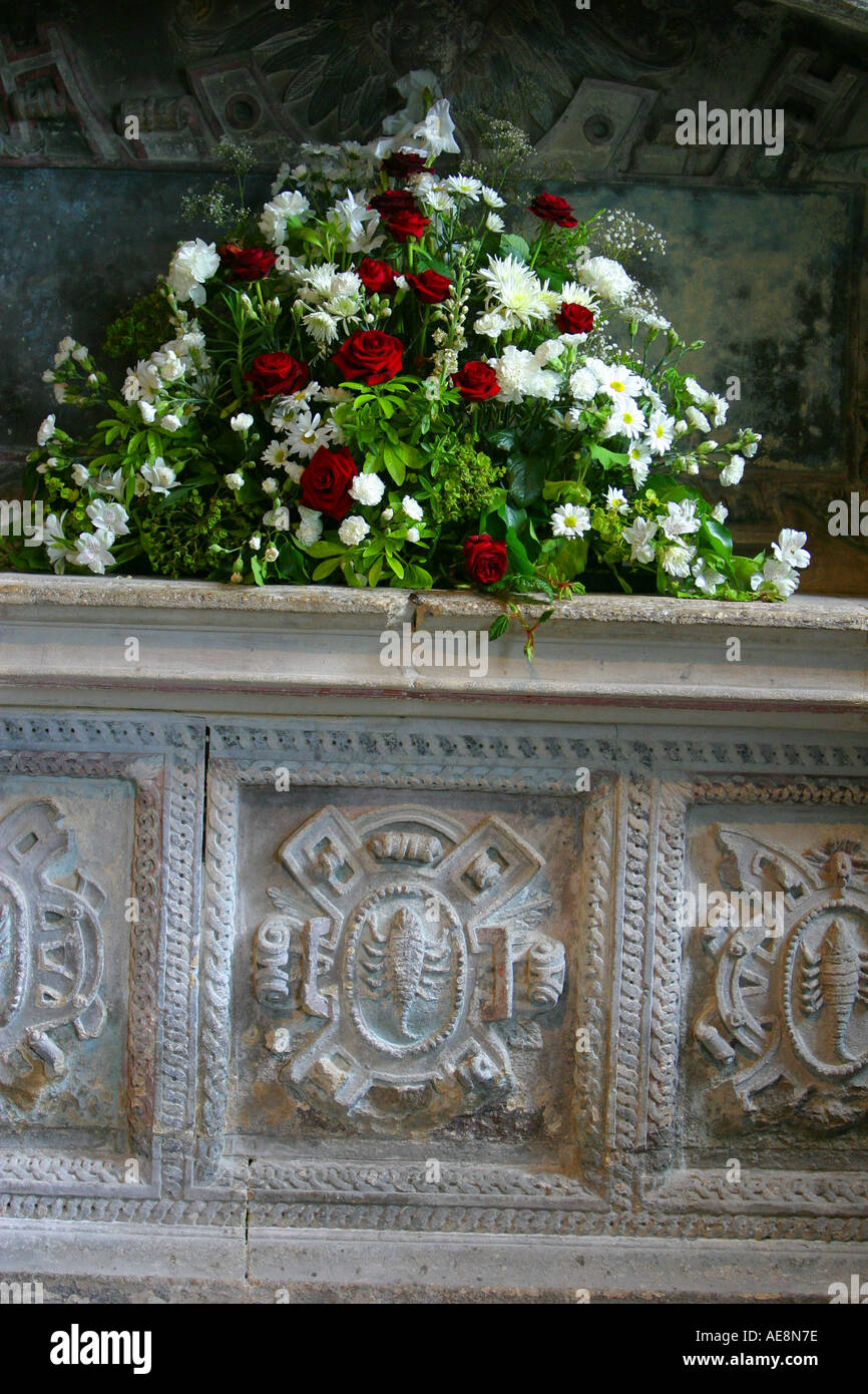 Flowers decorating ancient niche of knight's tomb in Lacock church ...