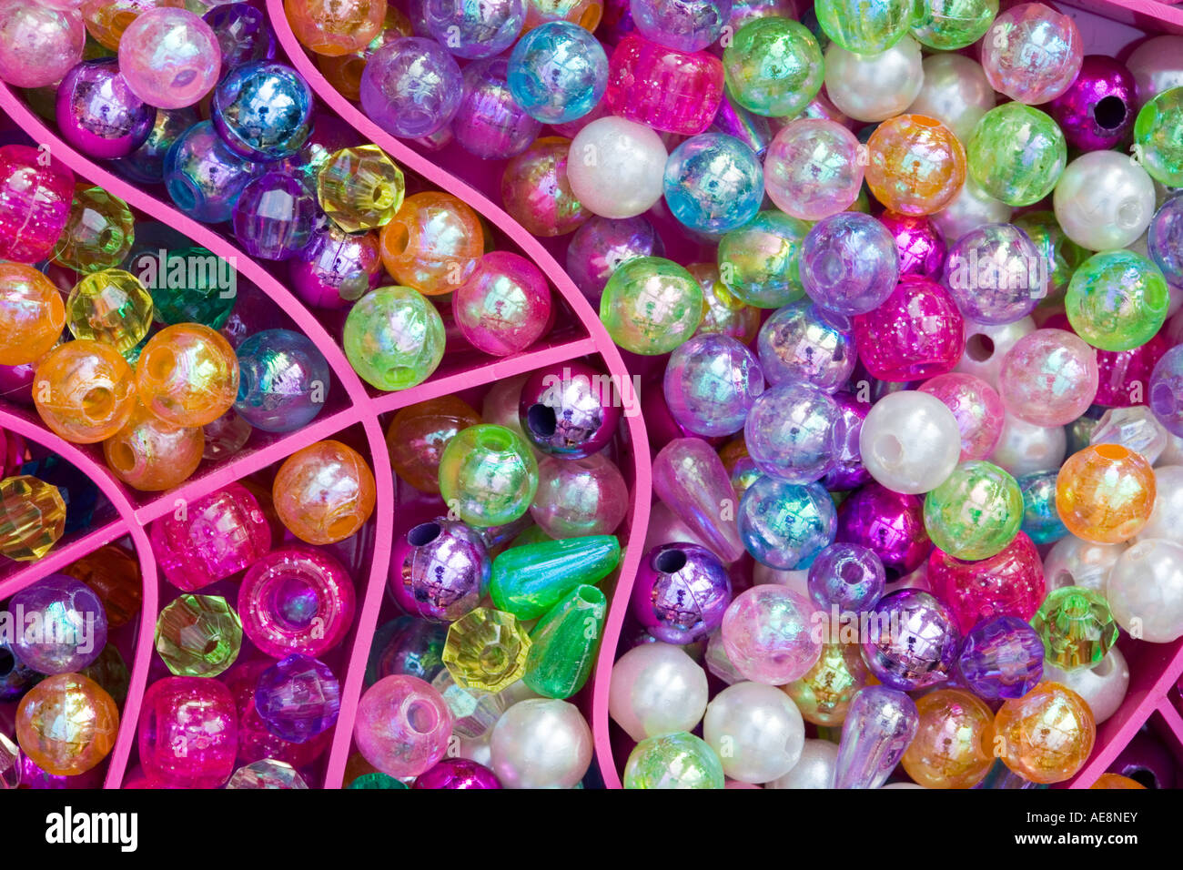 Colourful glass beads in a bright pink curved plastic box Stock Photo ...