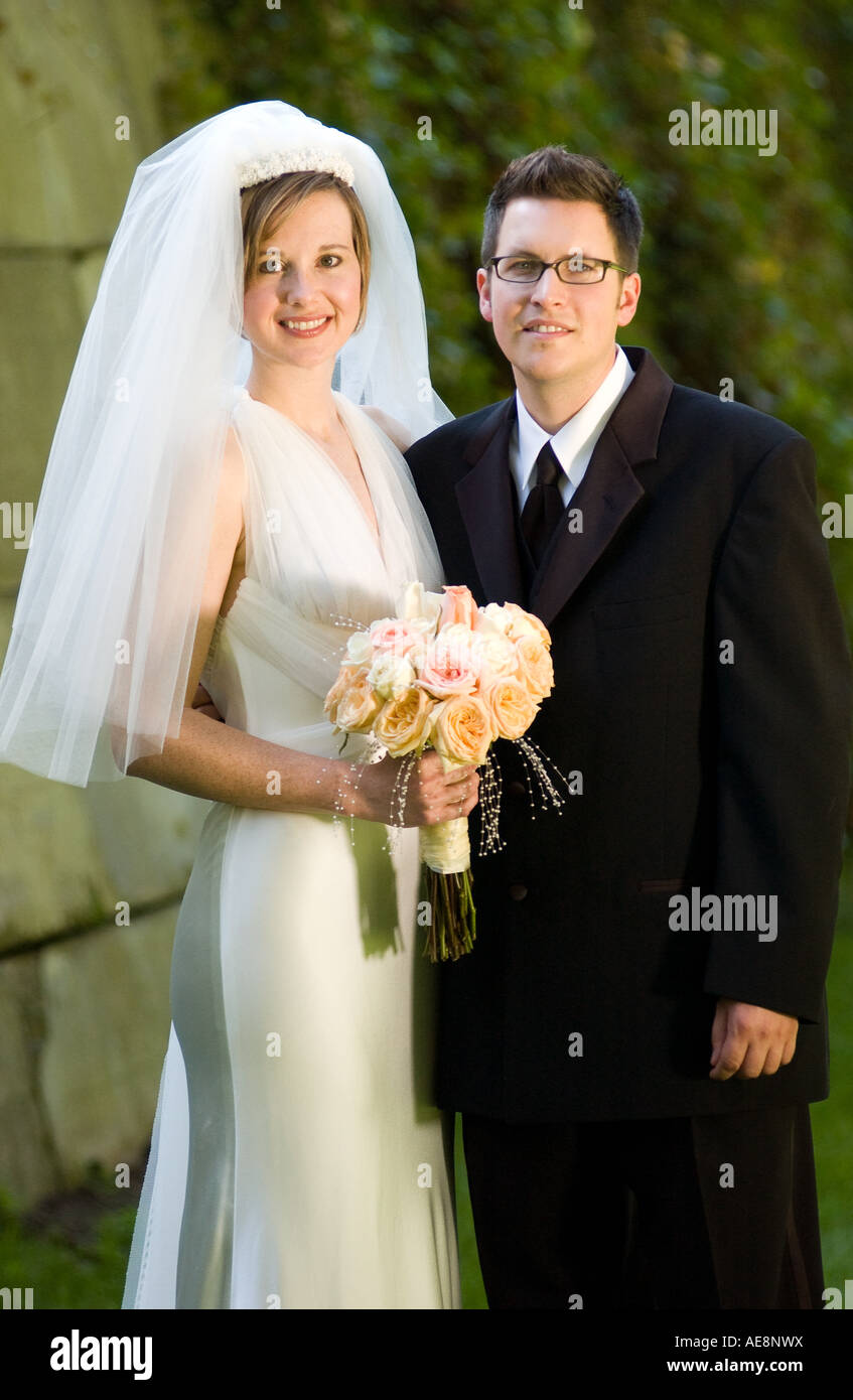 Portrait of bride and groom on their wedding day smiling outside Stock ...