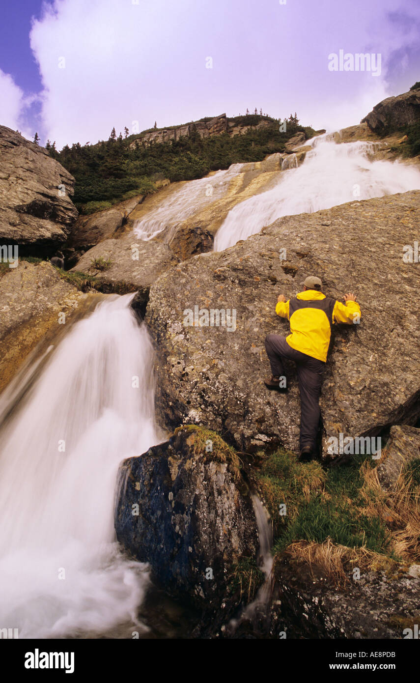 Hiker climbing rock Danny Moore Basin Babine Mountains Provincial Park ...